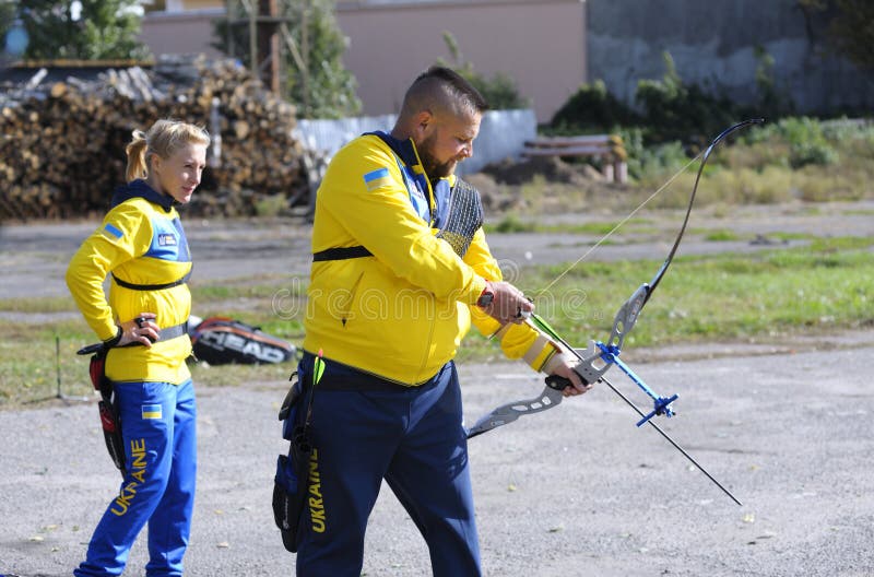 Man Archer Holding a Bow Aiming on an Archery Shooting Range Editorial ...