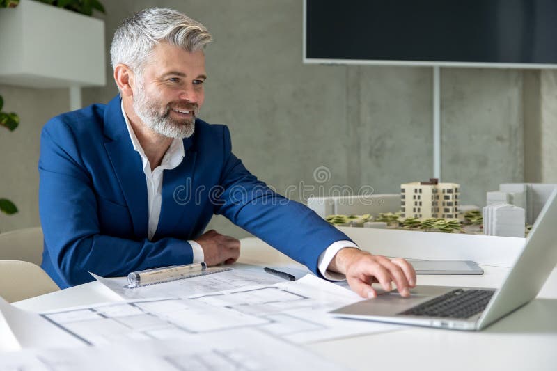 Man Architect with Beard Working on Some Project, Sitting at Table in ...