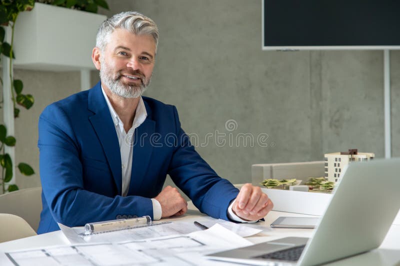 Man Architect with Beard Working on Some Project, Sitting at Table in ...
