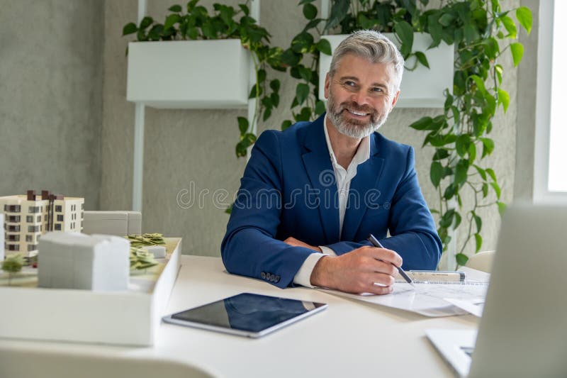 Man Architect with Beard Working on Some Project, Sitting at Table in ...