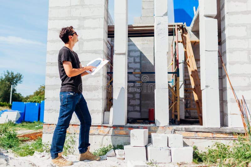 Man Architect Engineer Checking House Under Construction Comparing with ...