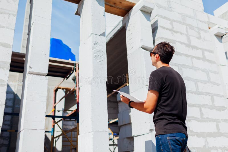 Man Architect Engineer Checking House Under Construction Comparing with ...