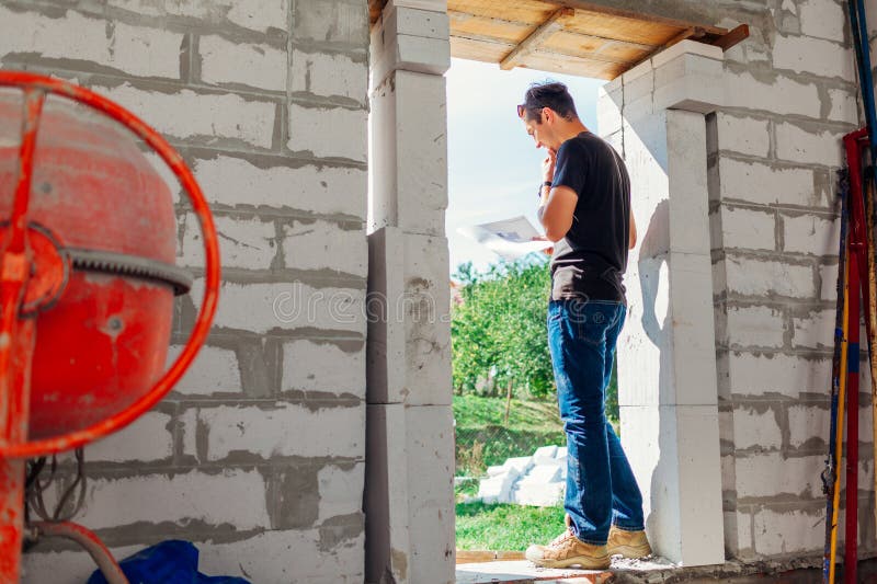 Man Architect Engineer Checking House Under Construction Comparing with ...