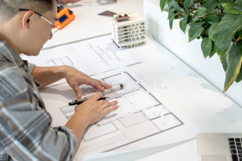 Man Architect Working with Blueprints Modeling Modern House. Stock ...