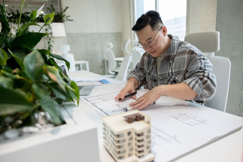 Man Architect Working with Blueprints Modeling Modern House. Stock ...