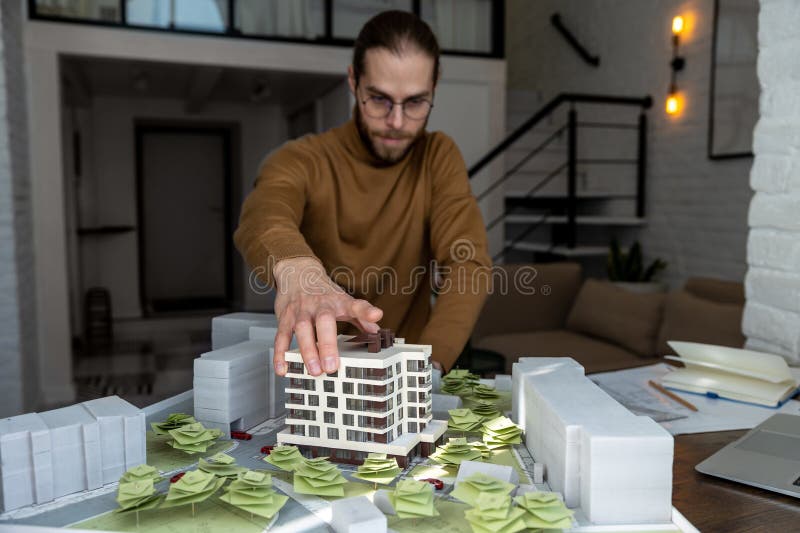 Man Architect Working with Blueprints Modeling Modern House. Stock ...