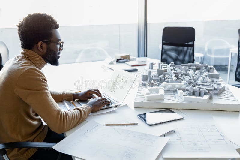 Man Architect Working with Software on Laptop Using Technical Drafts Drawings at Office ...