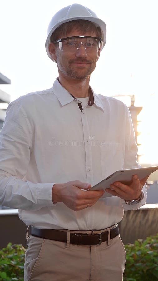 Man an Architectural Engineer, Wearing a White Shirt and Hard Hat, is ...