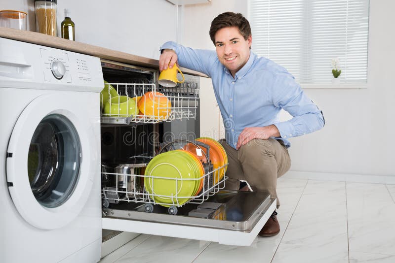 Man Arranging Dishes in Dishwasher Stock Image - Image of adult ...