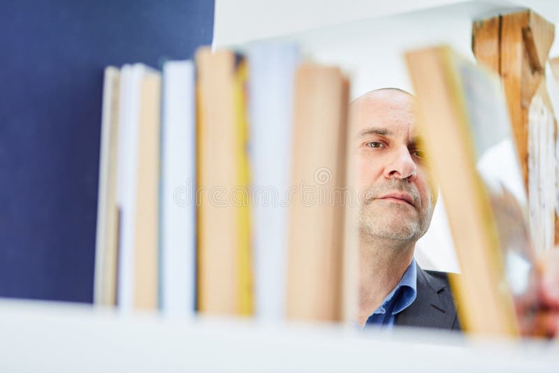 Man As Reader or Librarian Sorts Books Stock Photo - Image of searching ...