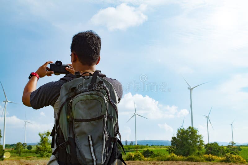 A Man Asian with Backpack Taking a Photo on View of the Wind Turbine ...
