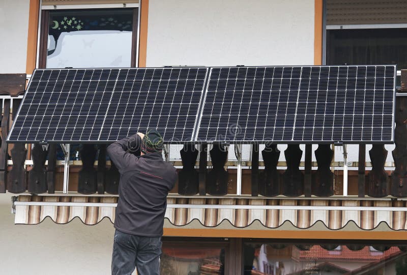 A Man Assembles a Balcony Power Plant To Generate Electricity Stock ...