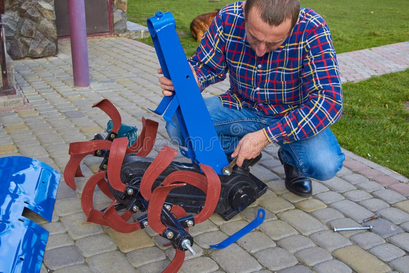 Man Assembles a Cultivator of the Walk-behind Tractor,work on ...