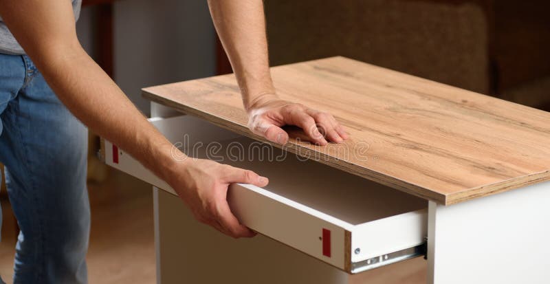 A Man Assembles a New Table with a Tools. Handyman Stock Image - Image ...