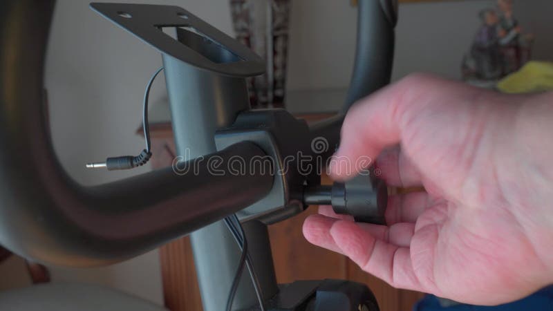 Man Assembling and Adjusting Exercise Bike Handlebars Stock Footage ...