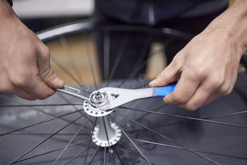Man Assembling a Bike Wheel Axle after the Process of Cleaning and ...
