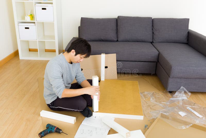 Man assembling cupboard stock image. Image of furniture - 35831247