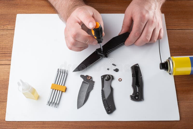 Man Assembling a Folding Knife with a Screwdriver Stock Photo - Image ...