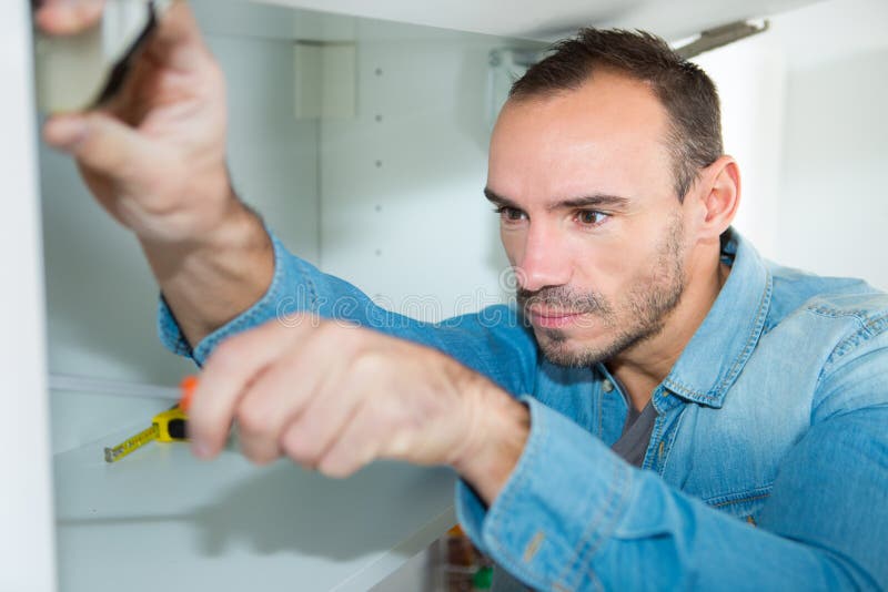 Man Assembling Kitchen Cupboard Stock Photo - Image of handmade ...