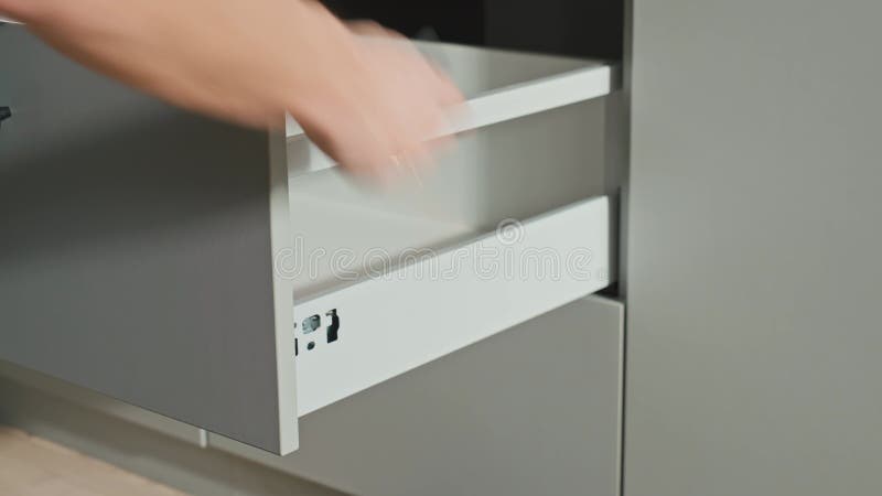 Carpenter Installing and Adjusting Drawer Front in Modern Kitchen ...