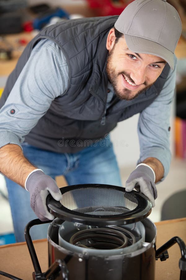 Man Assembling Metal Grill on To Fan Stock Photo - Image of maintenance ...