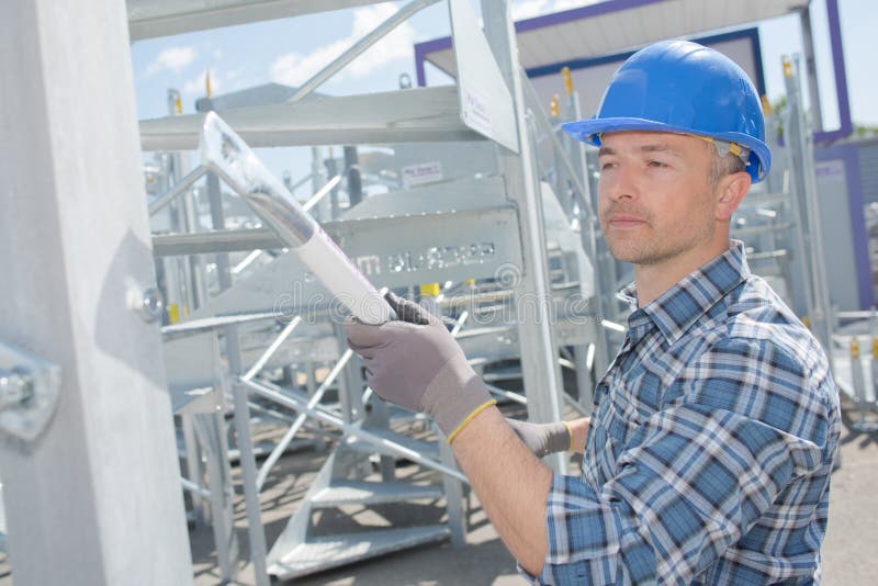 Man Assembling Metal Staircase Stock Photo - Image of ladder, metal ...
