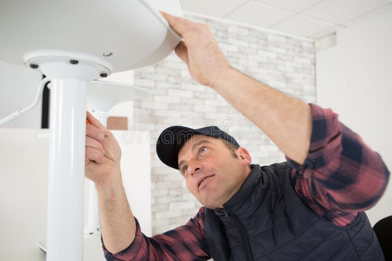 Man assembling metal stool stock photo. Image of contractor - 285317796