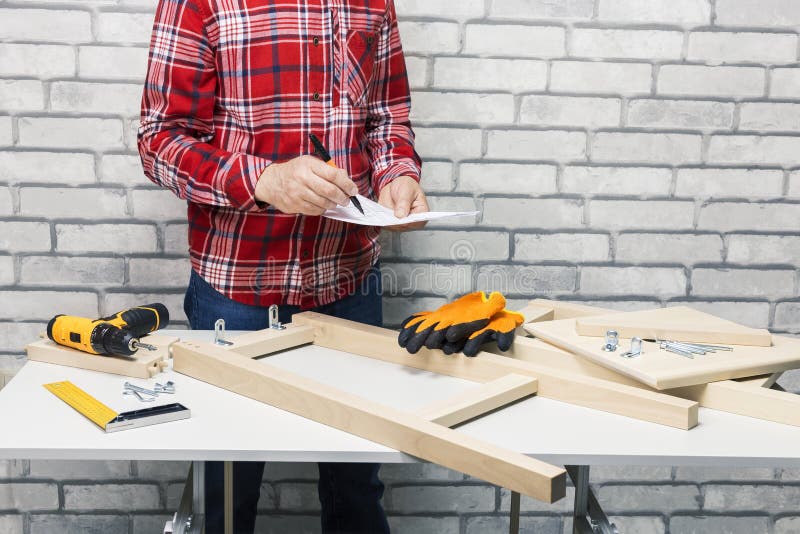 The Man Assembling New Furniture at His Home. Stock Photo - Image of ...