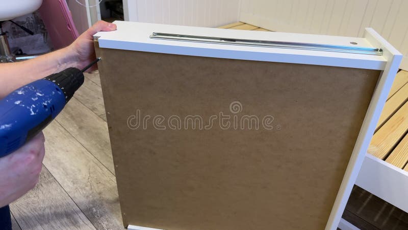 The Man is Assembling Pull-out Shelves for the Sofa Bed. he Installs ...