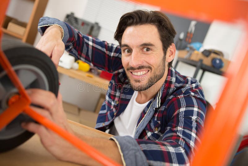 Man assembling sack truck stock photo. Image of manufacturing - 241148008