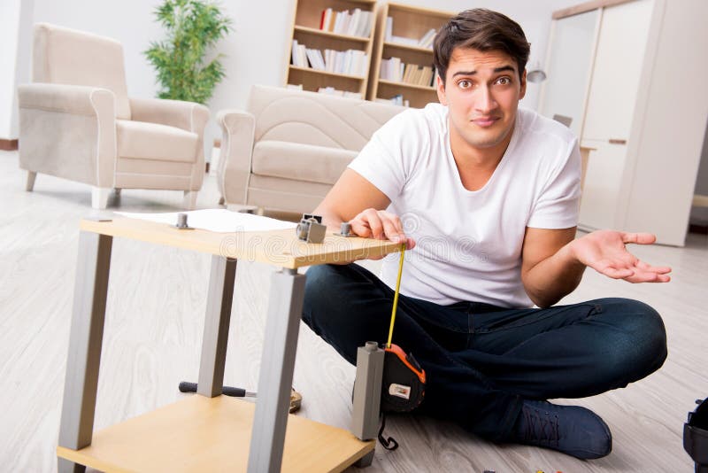The Man Assembling Shelf at Home Stock Photo - Image of puzzled ...