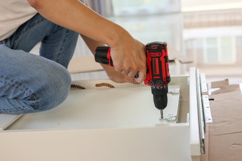 Man Assembling White Table Furniture at Home Using Cordless Screwdriver ...