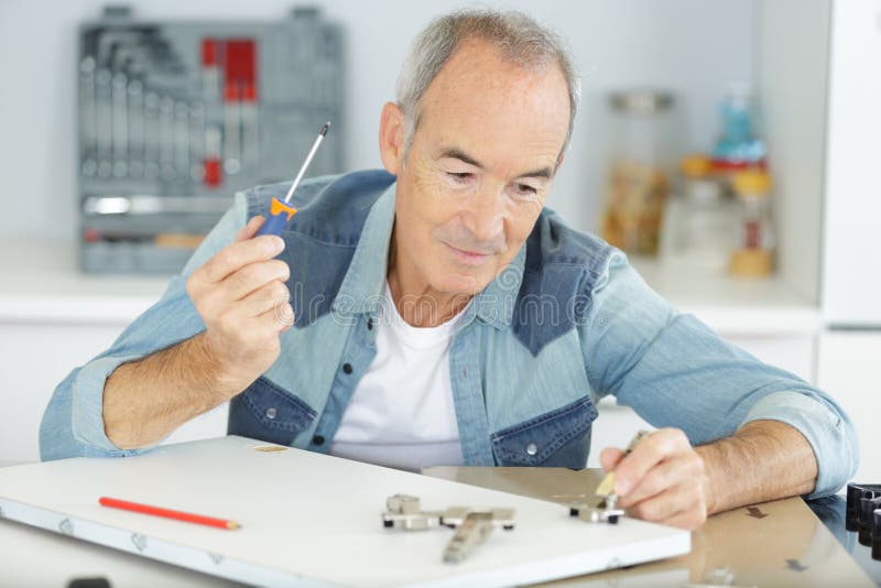 Man assembly furniture stock photo. Image of furniture - 200447806