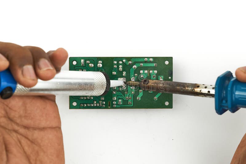 A Man Assembly a Green of Pcb (printed Circuit Board) with Soldering ...
