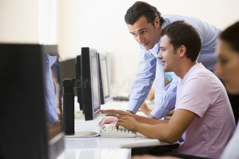 Man Assisting Other Man in Computer Room Stock Photo - Image of ...