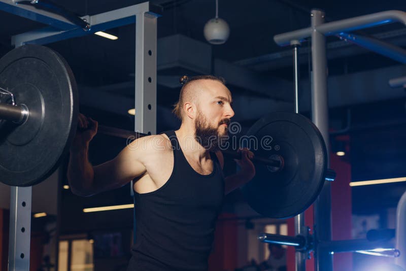 A Man of Athletic Build Does an Exercise with a Barbell Stock Image ...