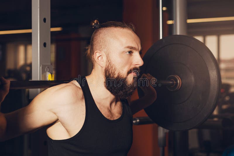 A Man of Athletic Build Does an Exercise with a Barbell Stock Image ...