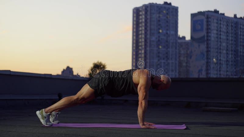 A Man with an Athletic Build Performs a Static Plank Exercise. Stock ...