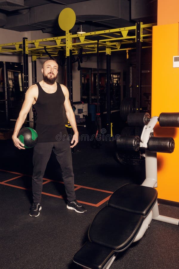A Man of Athletic Build Poses Against the Background Stock Photo ...