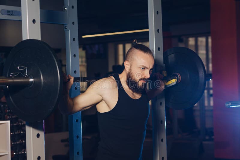 A Man of Athletic Build is Preparing To Perform an Exercise with a ...