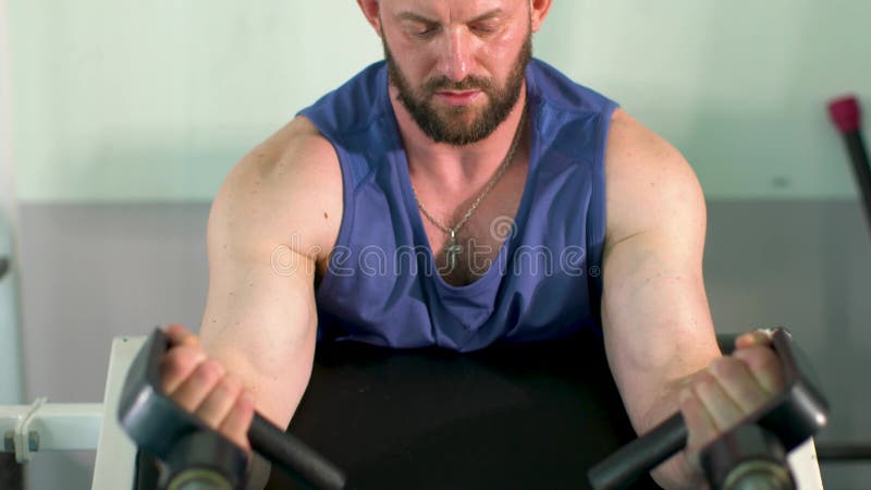 A Man of Athletic Build Exercises on a Machine in a Gym Stock Footage ...