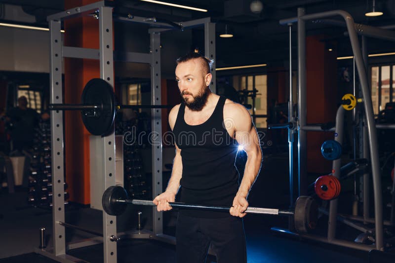 A Man of Athletic Build is Preparing To Perform an Exercise with a ...