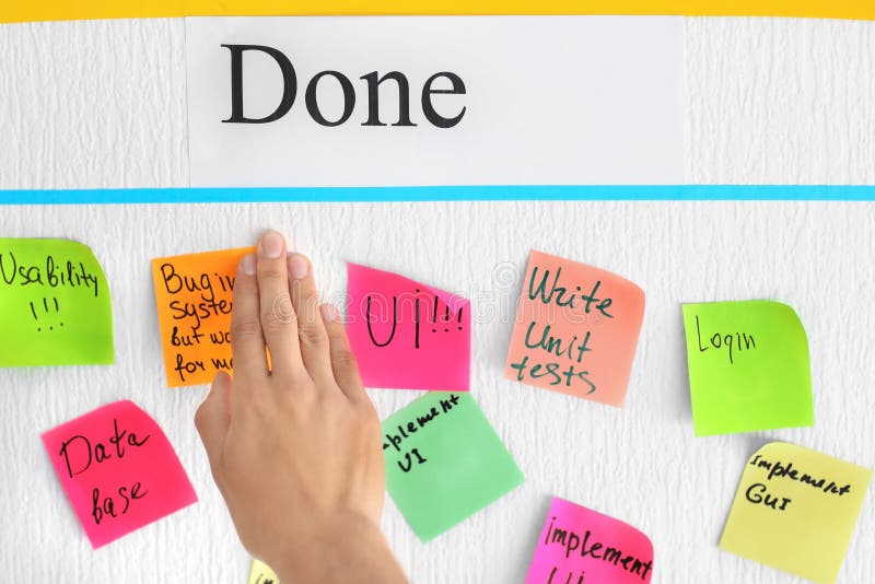 Man Attaching Sticky Note To Scrum Task Board in Office Stock Image ...