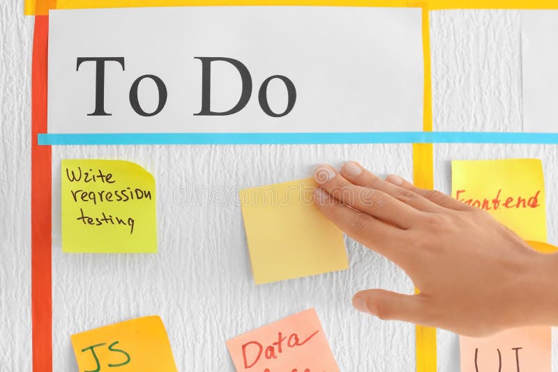 Man Attaching Sticky Note To Scrum Task Board in Office Stock Image ...