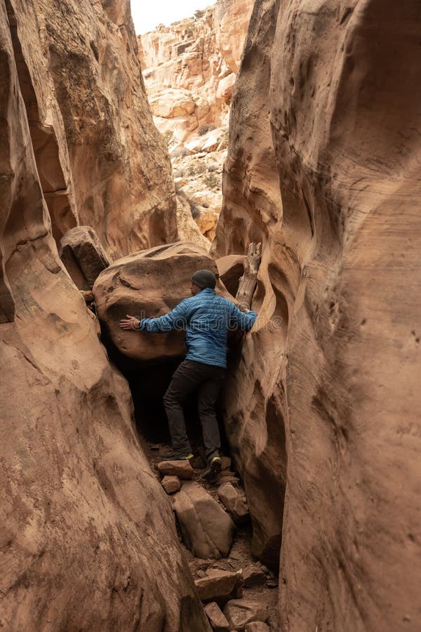 Man Attempts To Climb Over a Boulder Jam in Cotttonwood Canyon Stock Image - Image of capitol ...