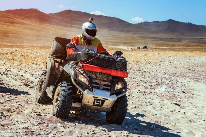 Man on ATV Rides through the Mountainside Stock Photo - Image of person ...