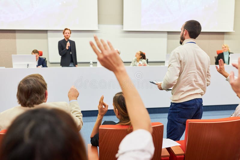 Man in Audience Asking Question To Speaker at Business Event Stock ...