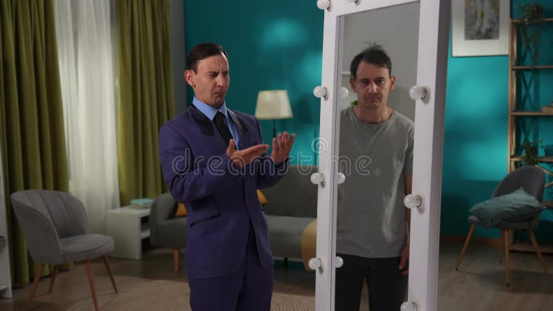 A Man in an Austere Suit Stands in a Living Room in Front of a Mirror ...