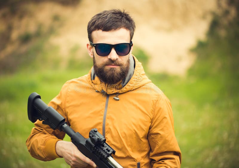 A Man with an Automatic Rifle Stock Photo - Image of outdoors, military ...