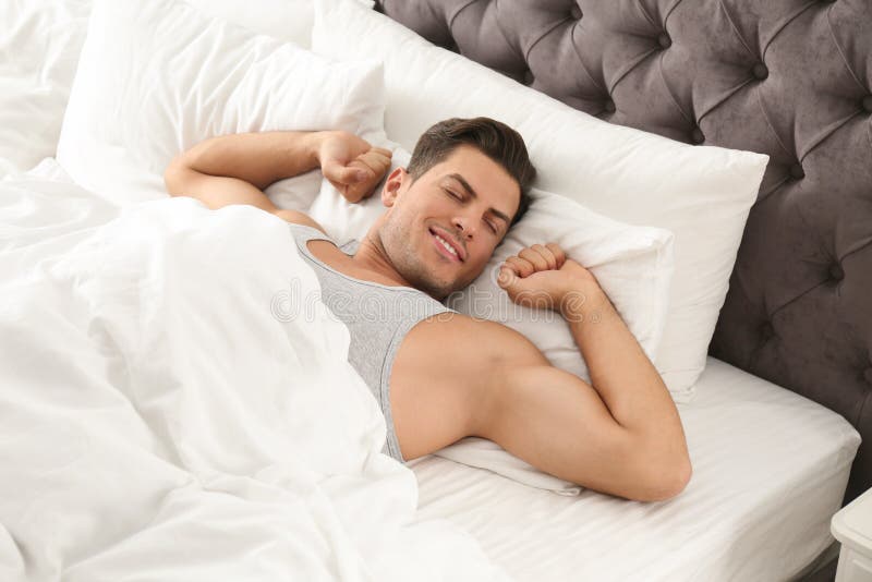 Man Awakening on Bed at Home Stock Image - Image of cozy, male: 169857209